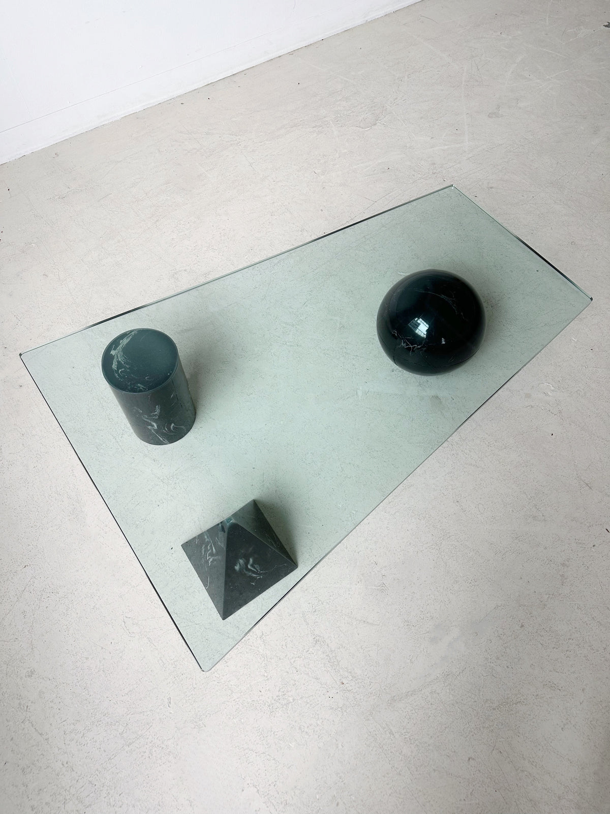 TRAPEZOID GLASS COFFEE TABLE WITH GEOMETRICAL BASE | Maison Singulier
